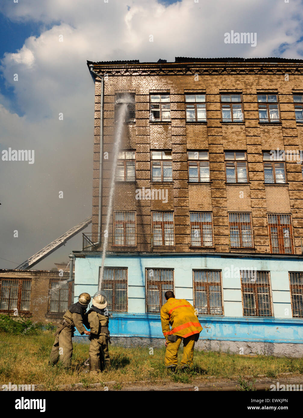 extinguishing a fire in an old three-storey building Stock Photo - Alamy