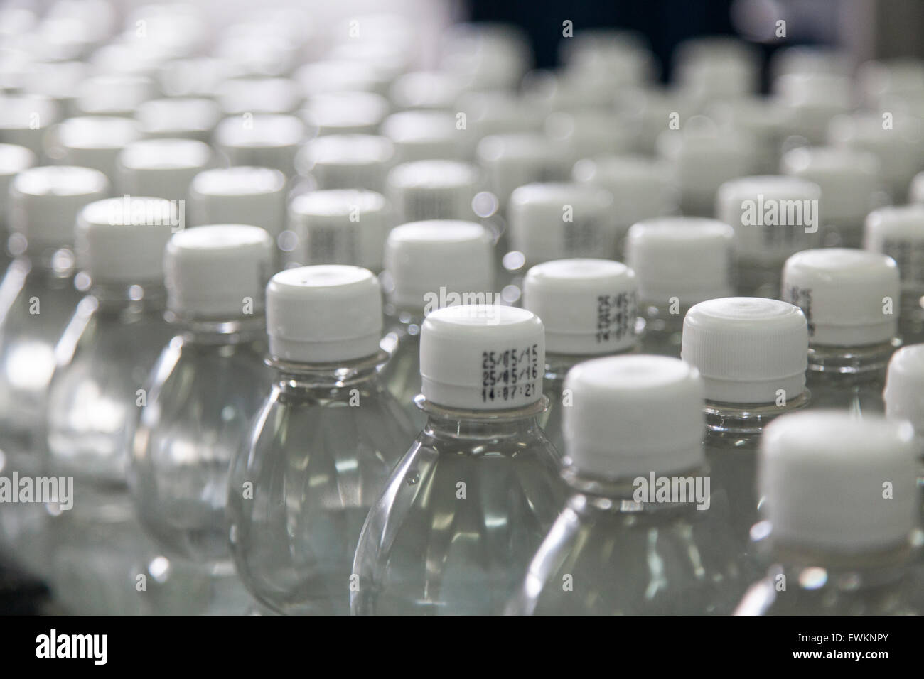 Bottle filled with water standing on the assembly line Stock Photo - Alamy