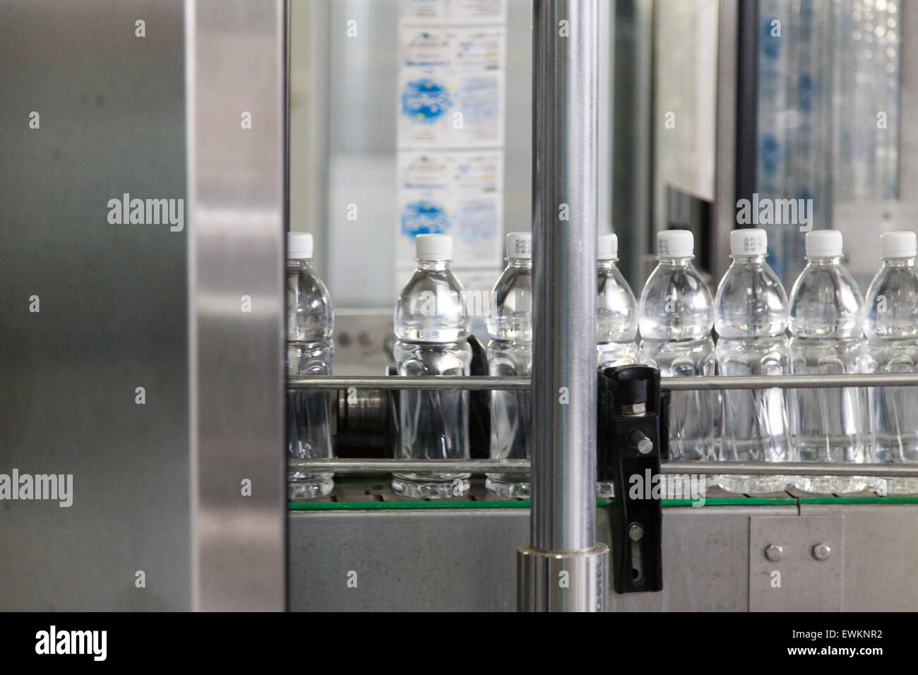 Bottle filled with water standing on the assembly line Stock Photo - Alamy