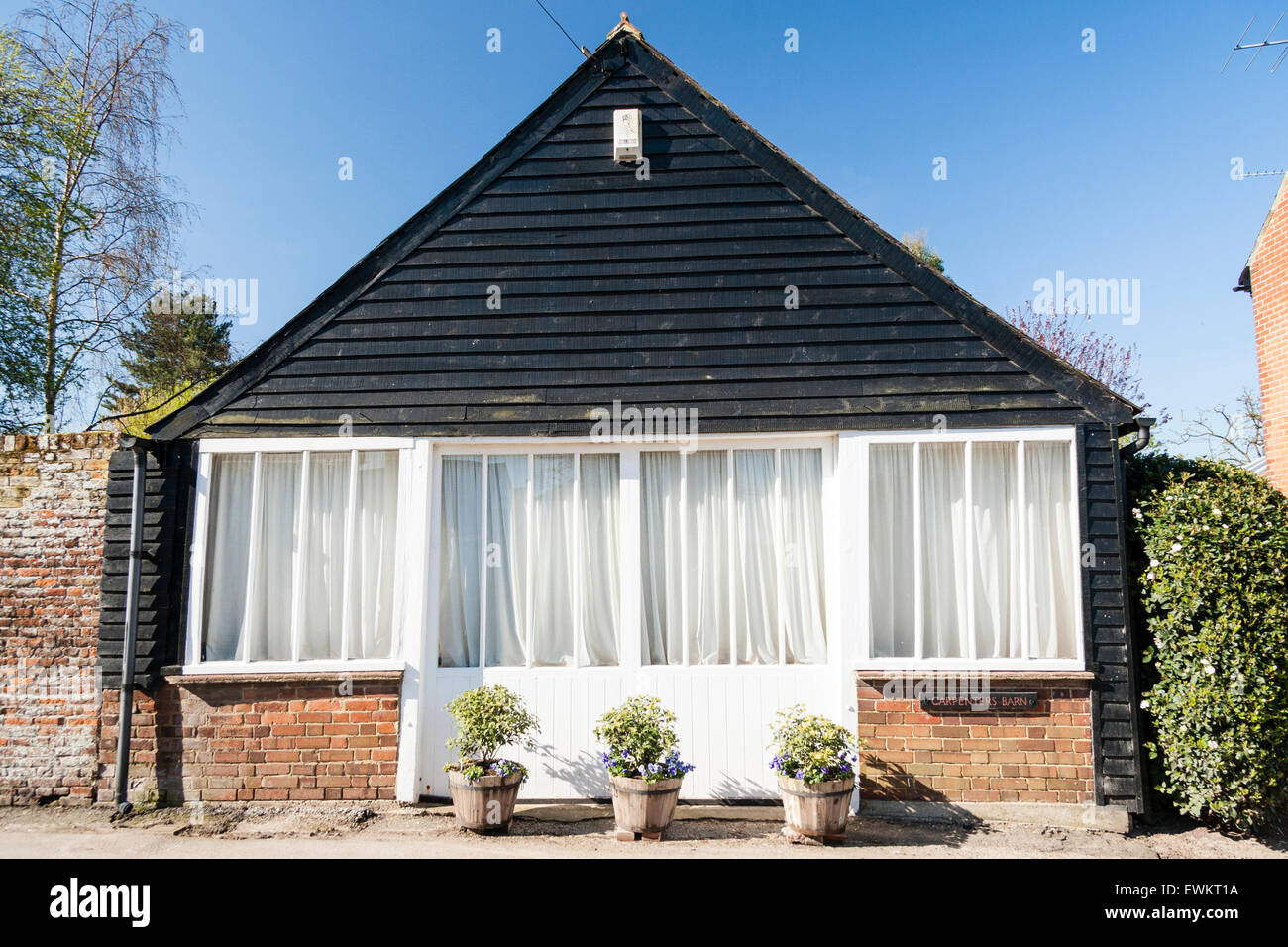 The Kent village of Ickham in England. Carpenter's Barn, converted into ...