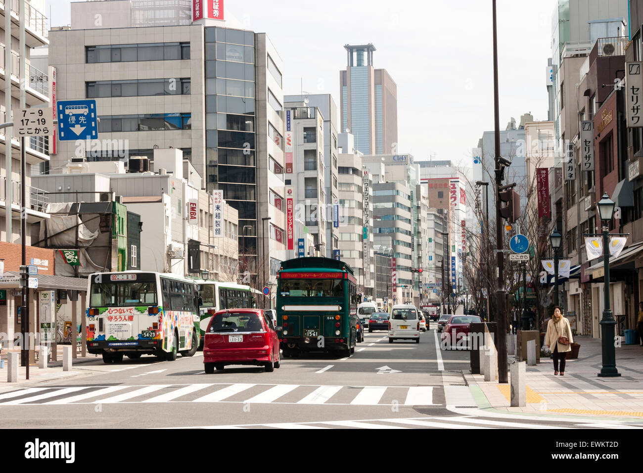 Japan, Kobe, Sannomiya. Street scene. Pedestrian crossing in foreground ...