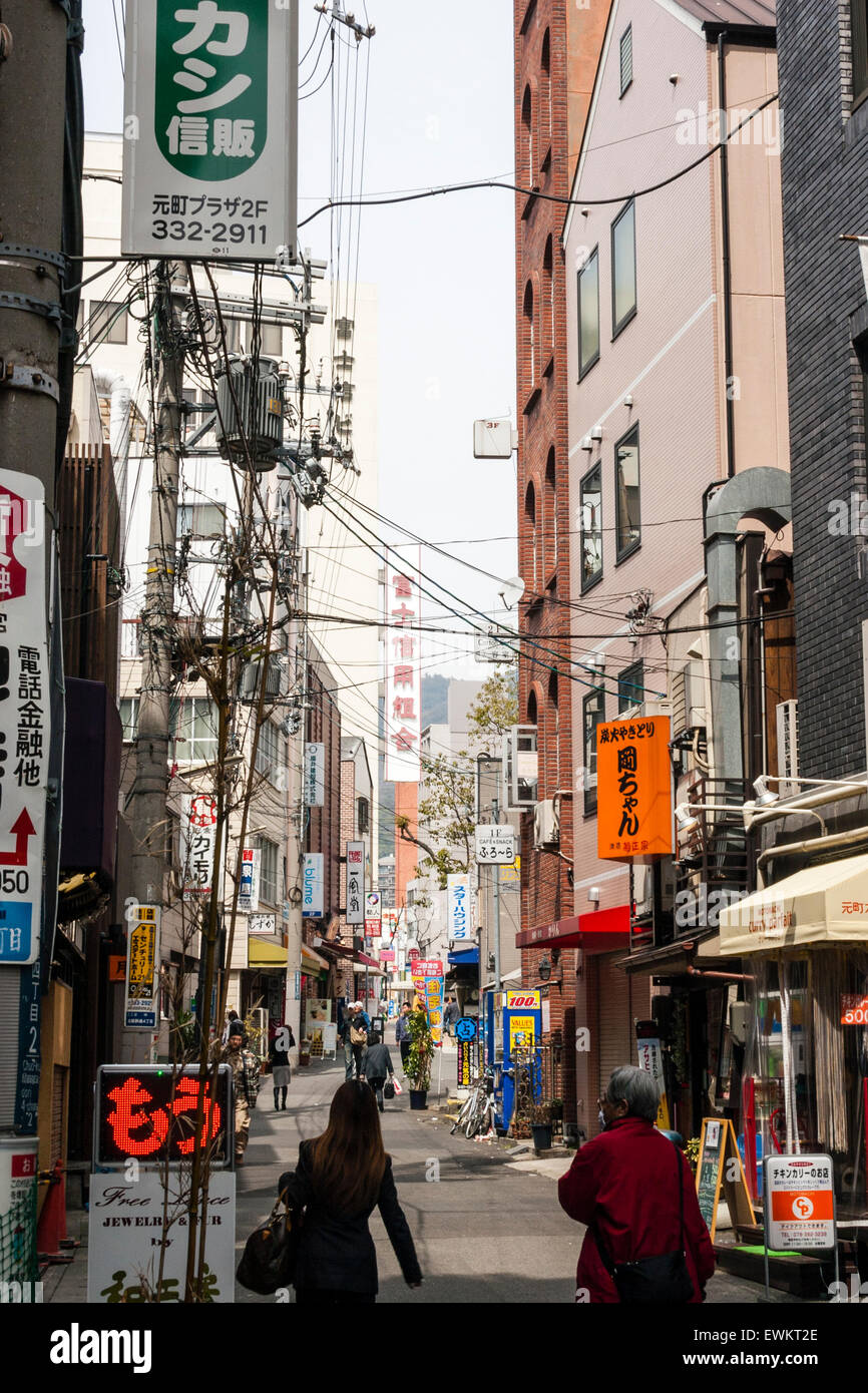 Typical Japanese city street scene. Narrow road between two rows of ...