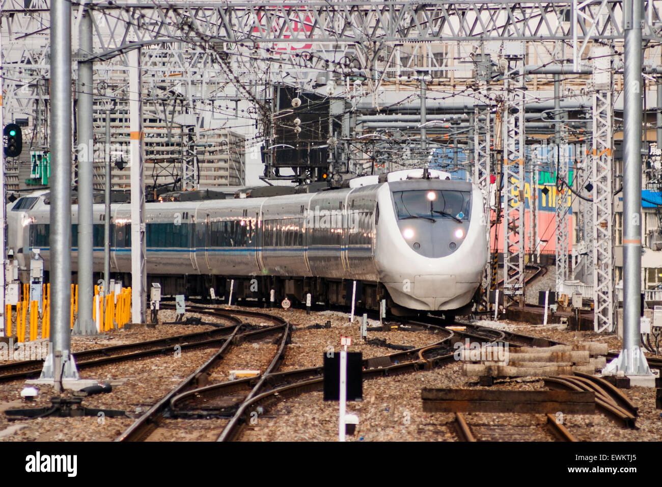 Japan, Osaka station. Japanese commuter train approaching along mass of ...