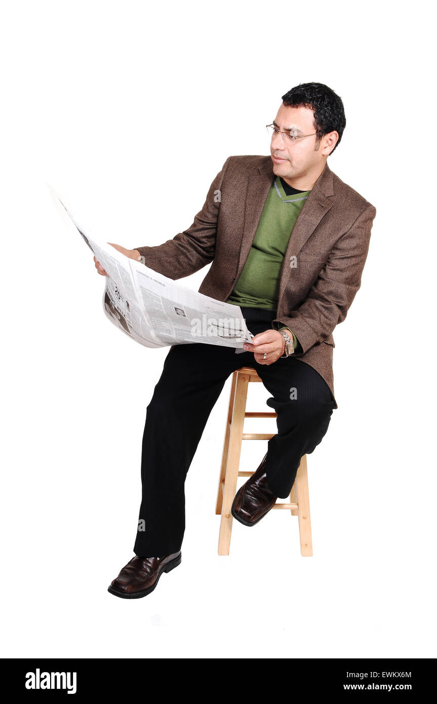 An middle ages man sitting and reading the newspaper in dress pants and ...
