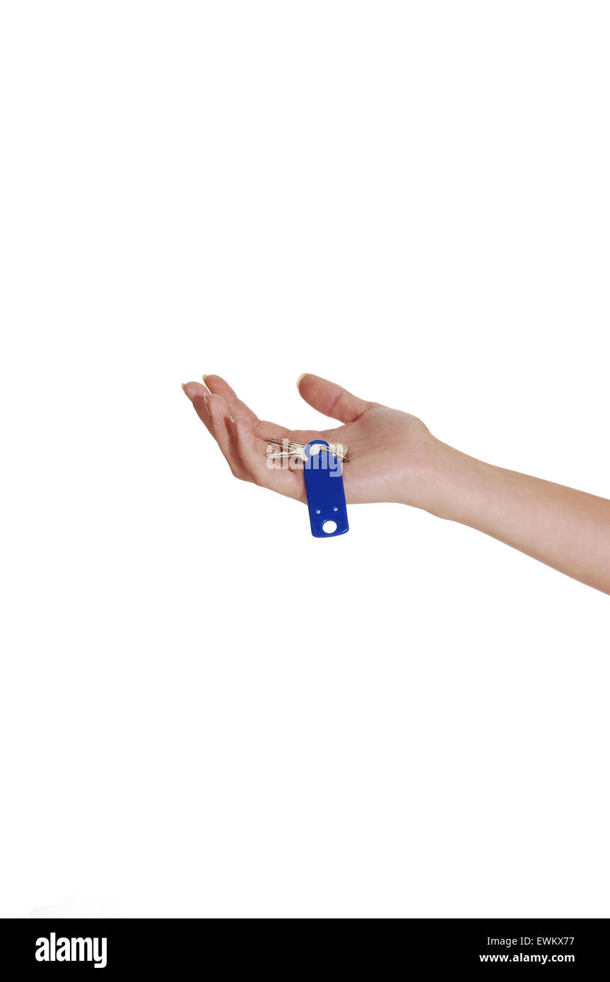 The hand of a woman holding a key with a blue label, for white ...