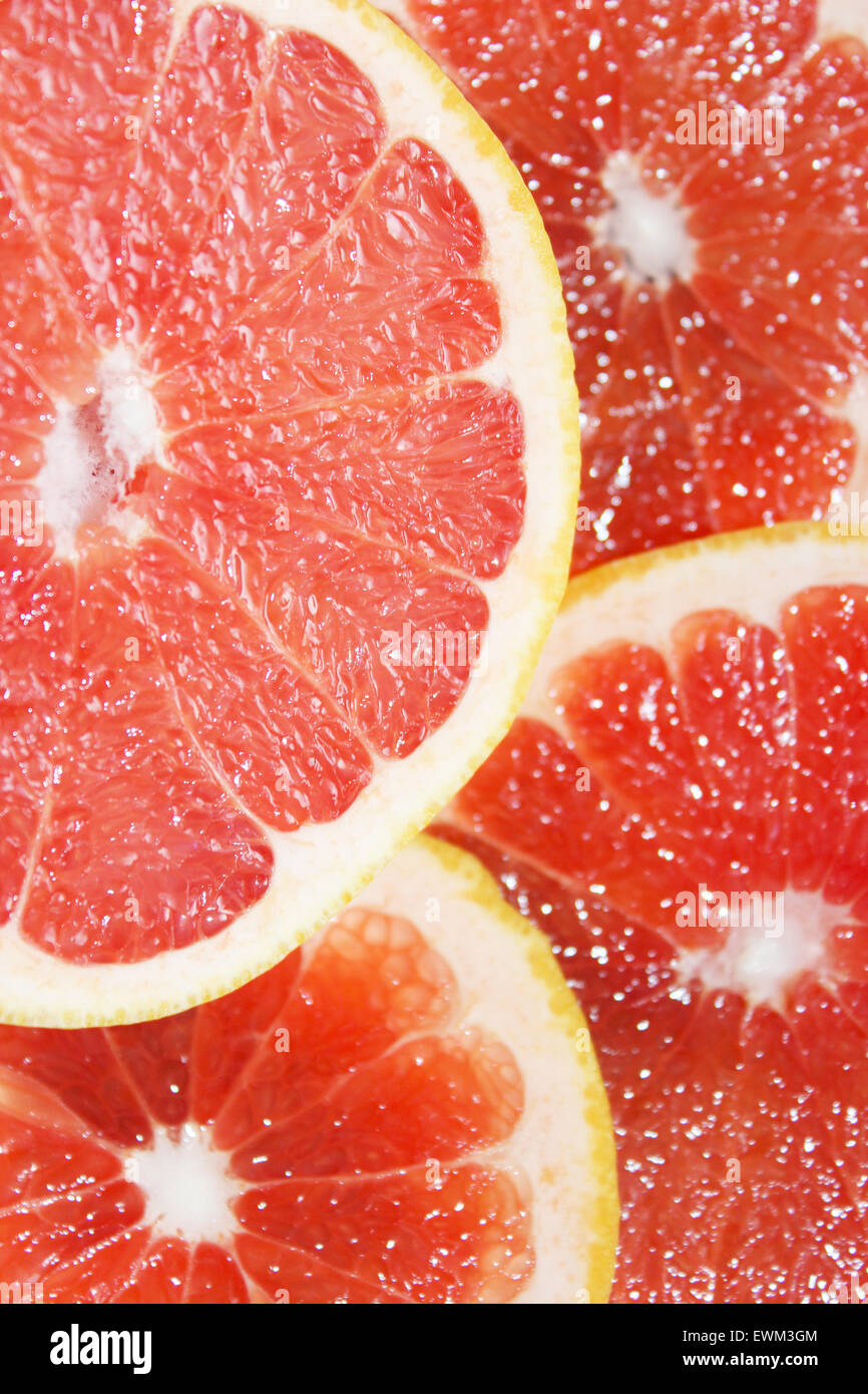 cut fruit of red grapefruit on the board Stock Photo - Alamy