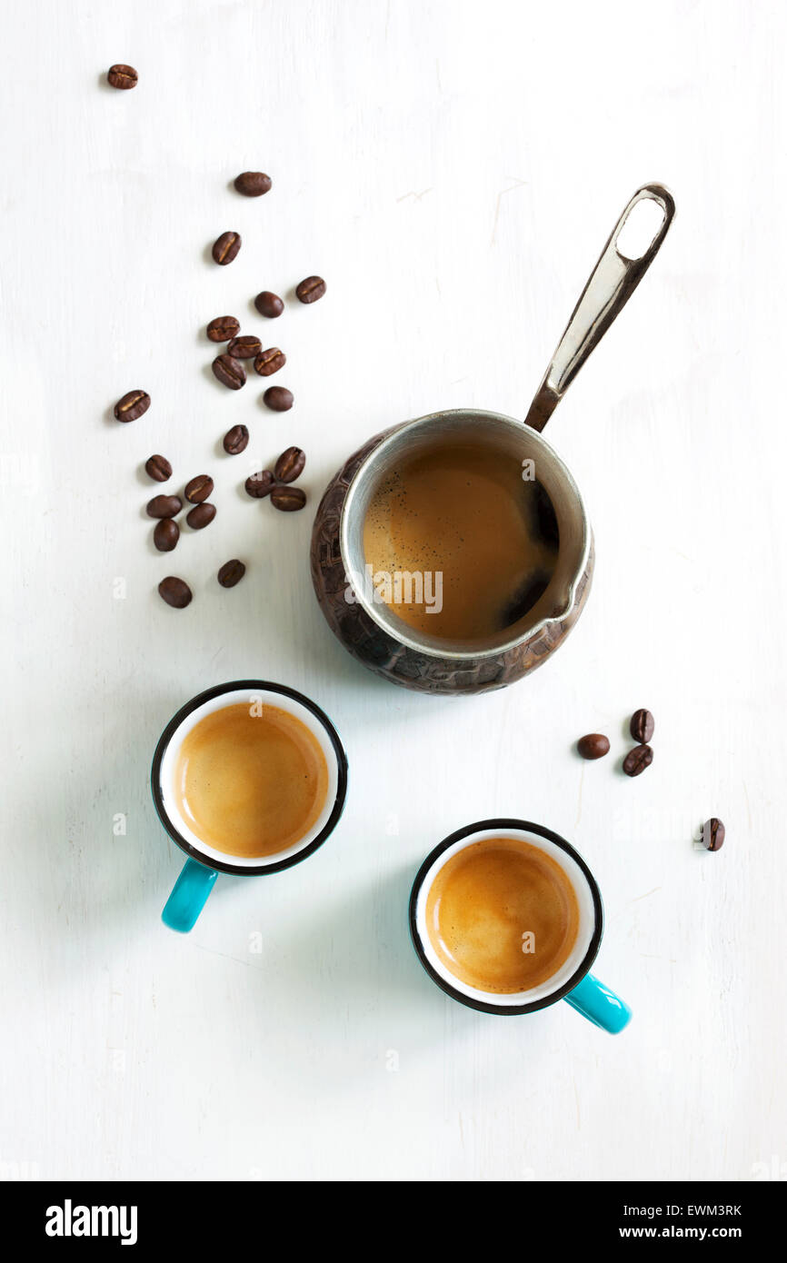 Cups of coffee and coffee pot. Top view Stock Photo - Alamy