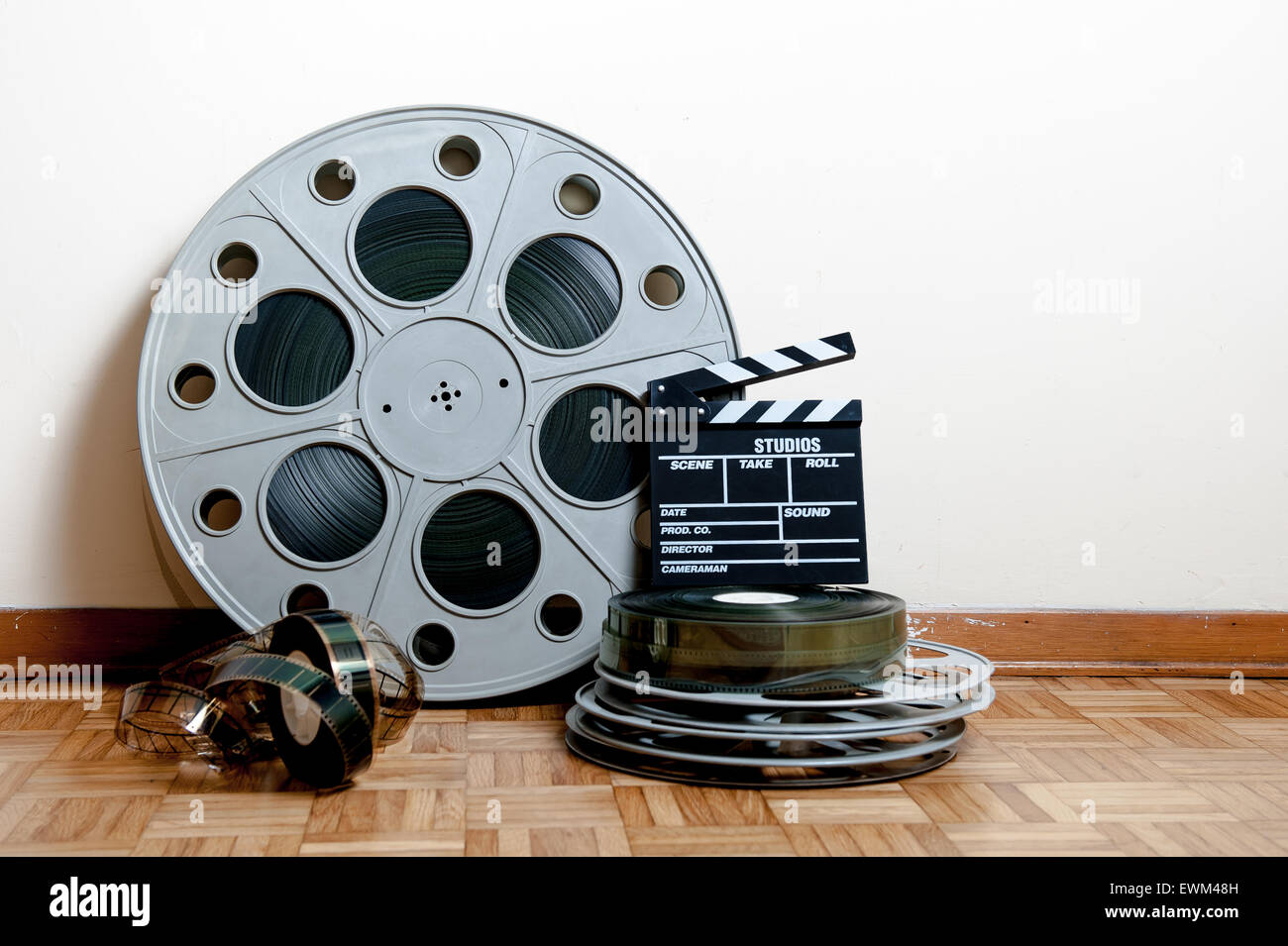 35 mm cinema movie roll and reels with clapper and filmstrip on wooden ...