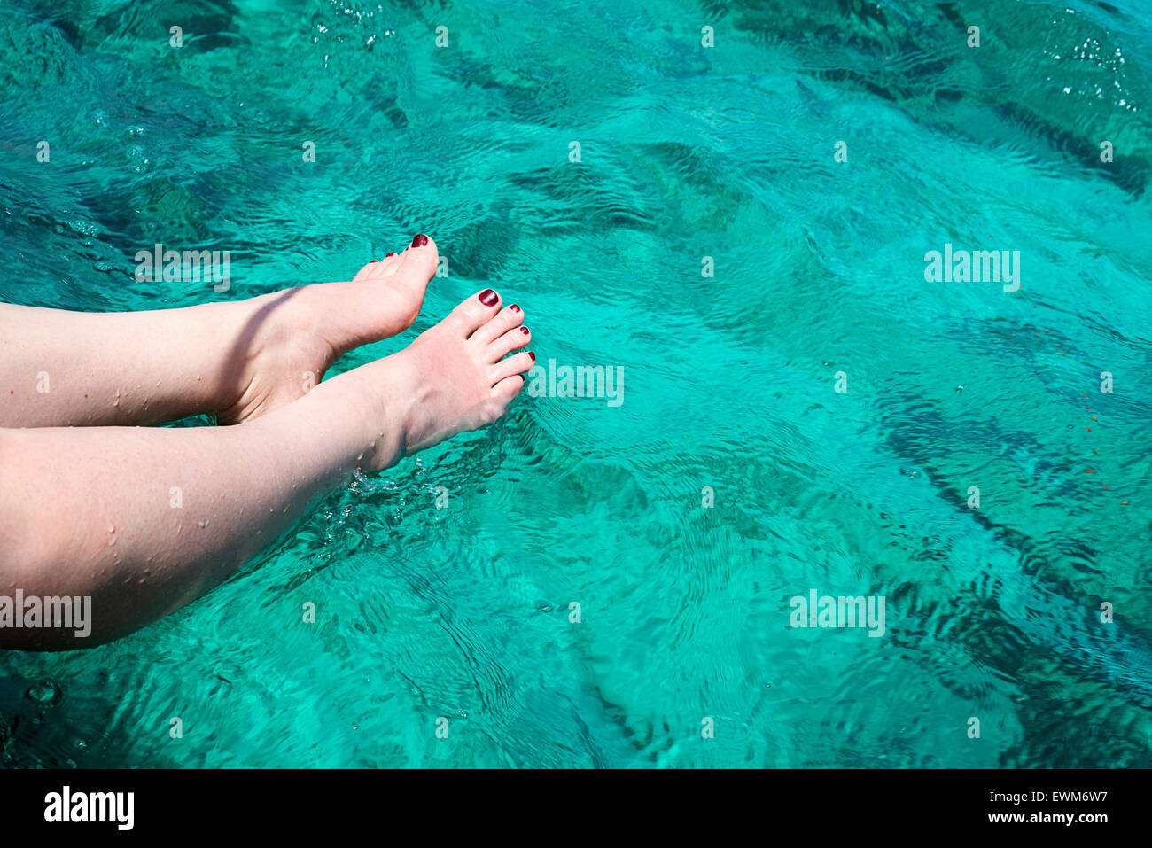 A woman's manicured feet and the water Stock Photo - Alamy