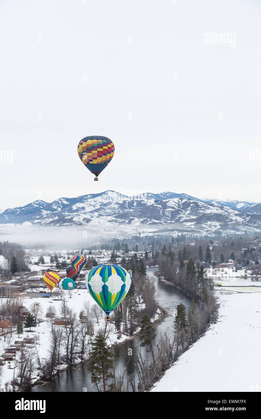A hot air balloon rises from the snow covered ground at the Winthrop ...