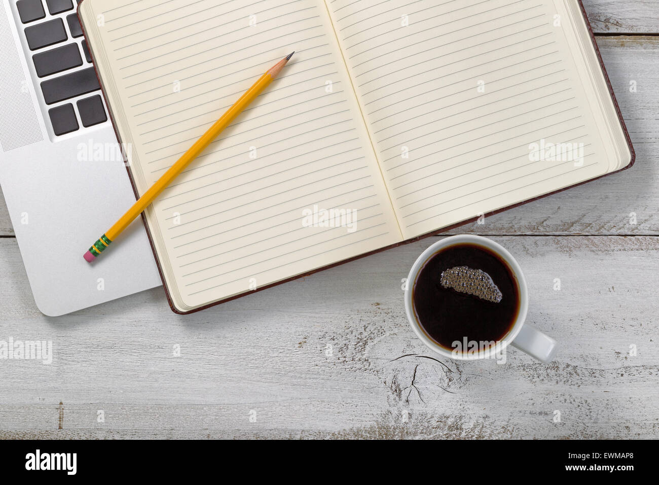 Old white wooden desk with laptop, notepad, pencil and dark coffee ...