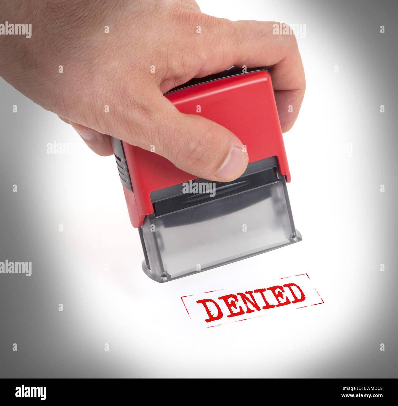 Plastic stamp in hand, isolated on white - Denied Stock Photo - Alamy