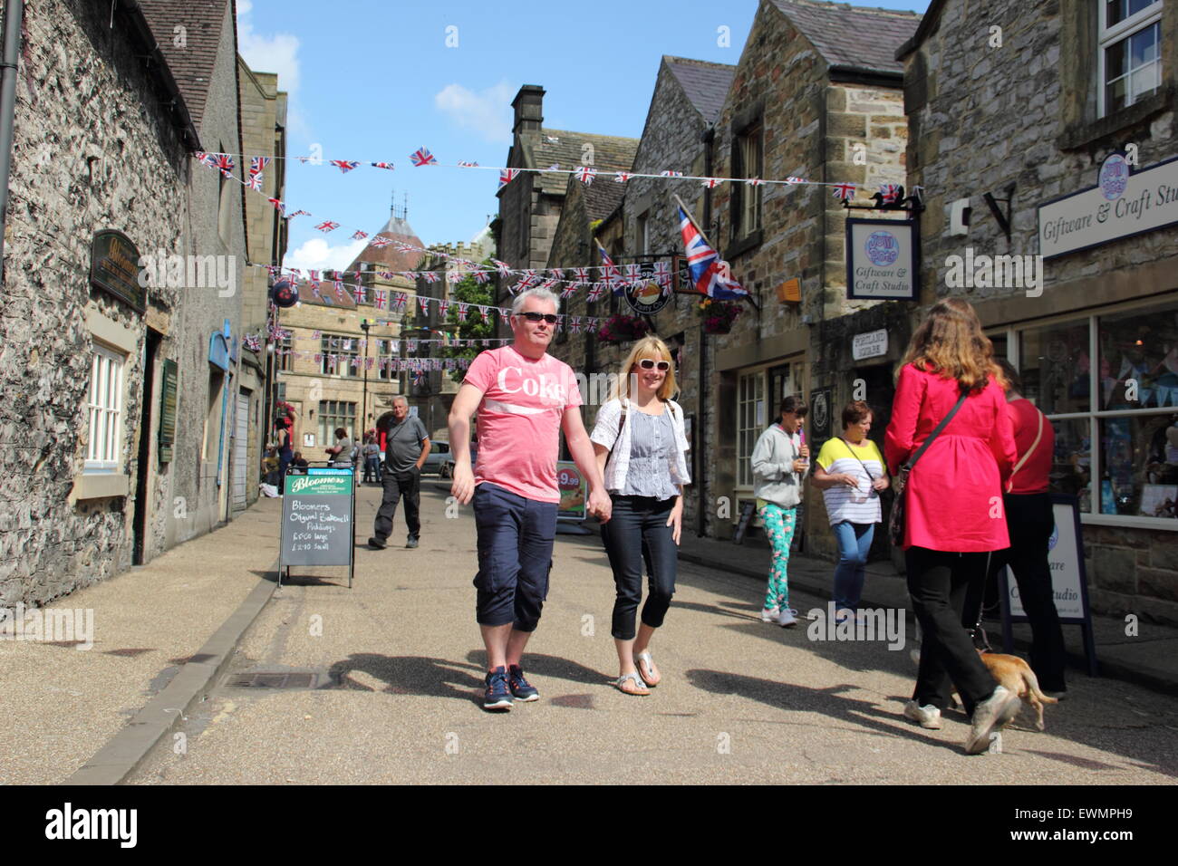 People walk through a pretty street in Bakewell, Peak District ...