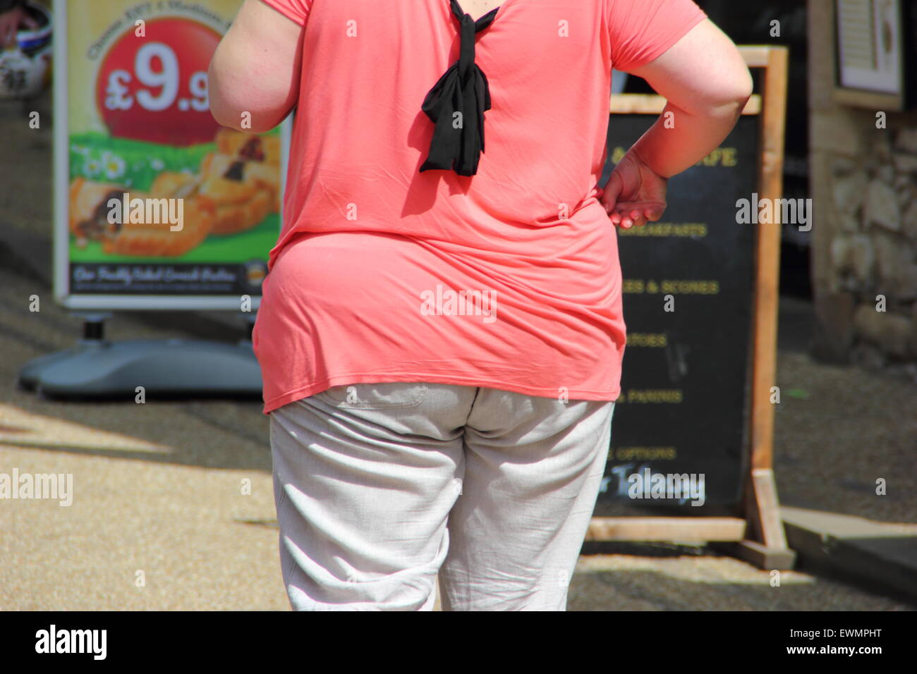 Overweight adult female in a high street in England, . Patial view ...