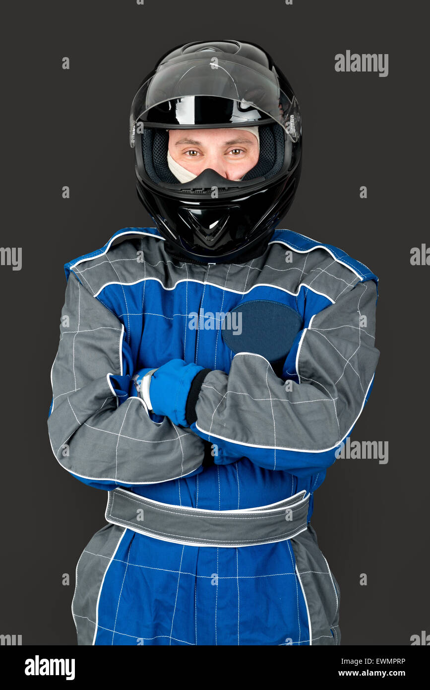Racing driver posing with helmet isolated in a dark background Stock ...