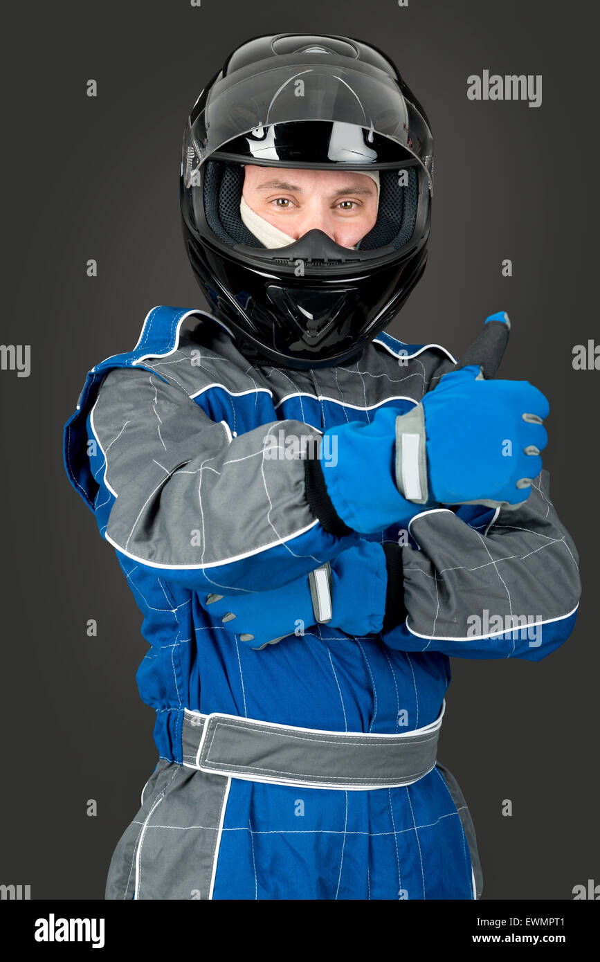 Racing driver posing with helmet isolated in a dark background Stock ...