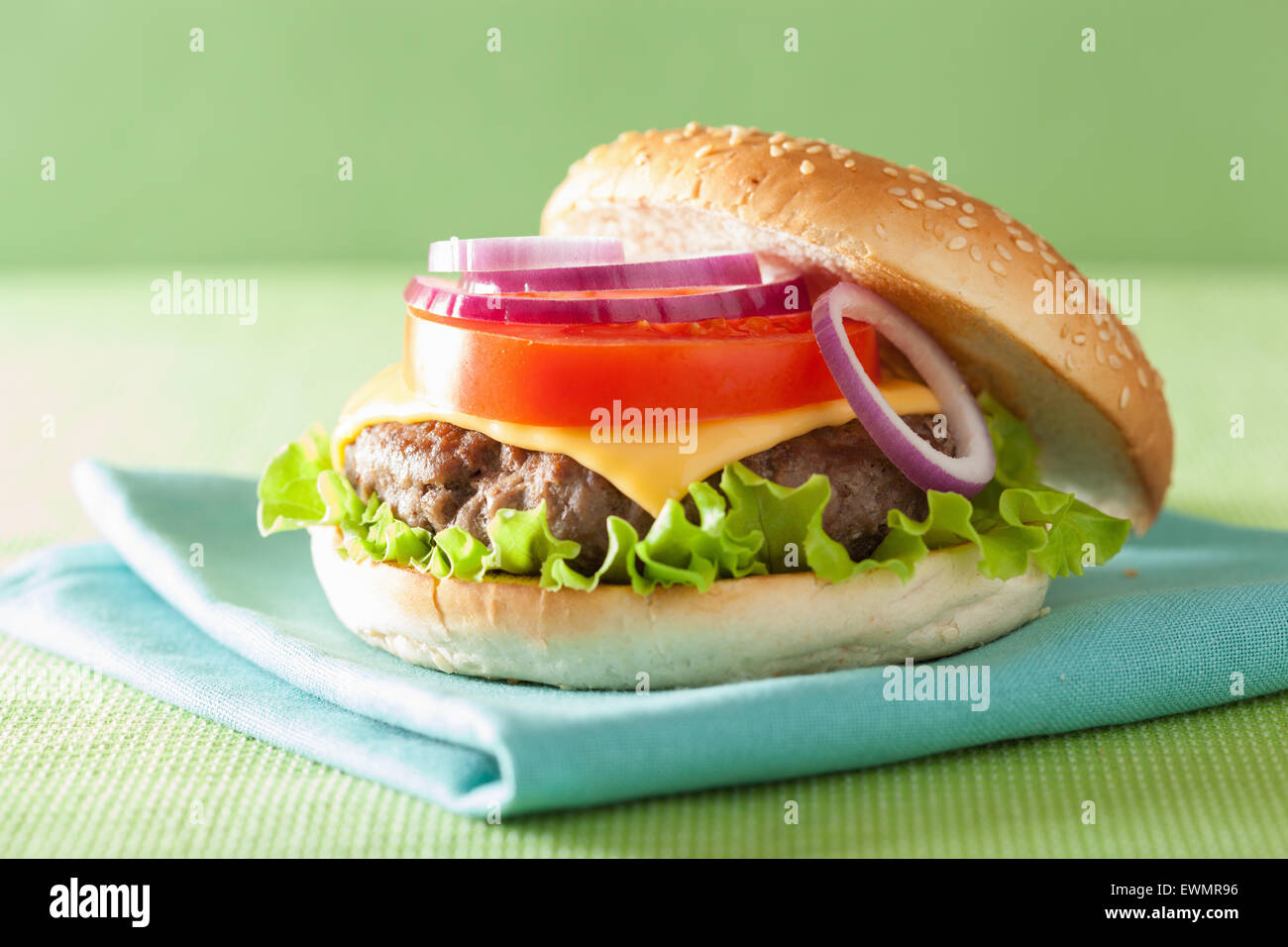 burger with beef patty cheese lettuce onion tomato Stock Photo - Alamy