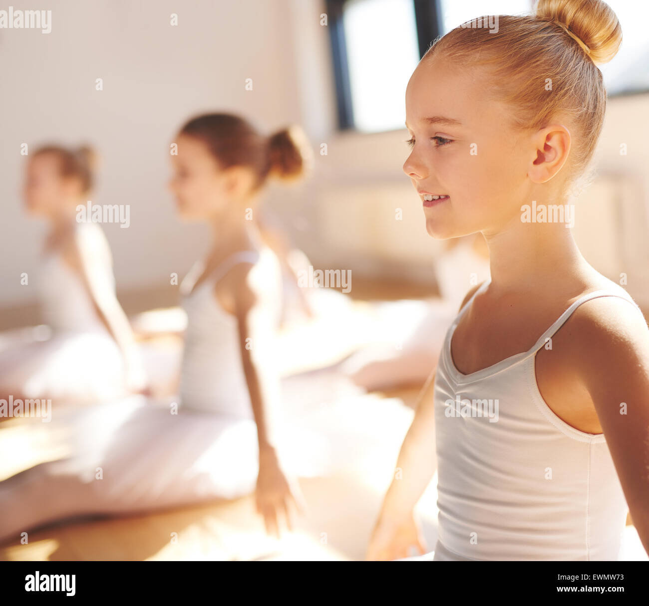 Close up side view of the face of a cute pretty little blond ballerina ...