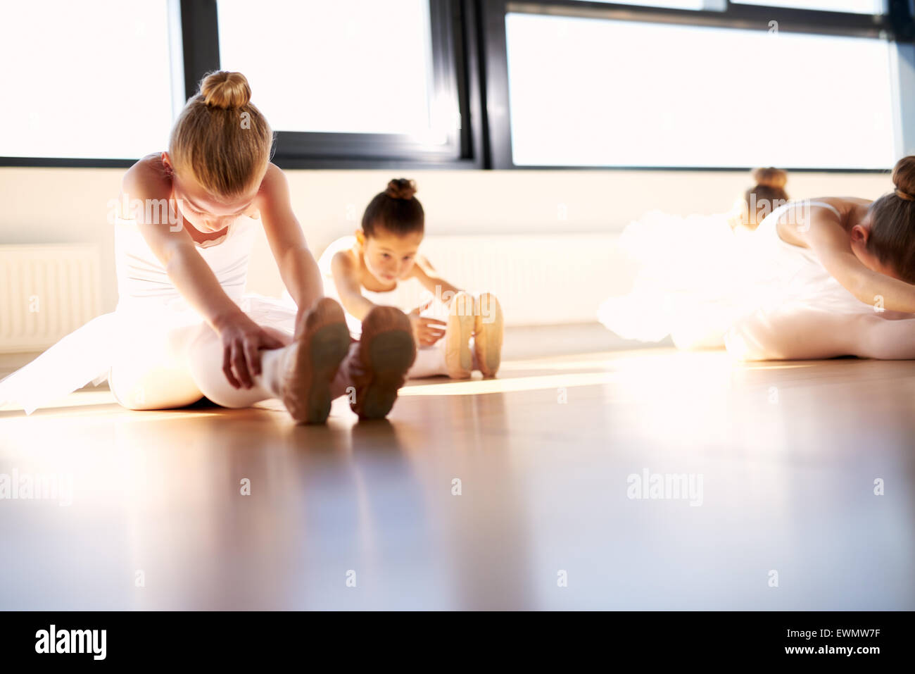 Little Ballet Girls Doing a Sit and Reach Warm-up Exercise for Body ...