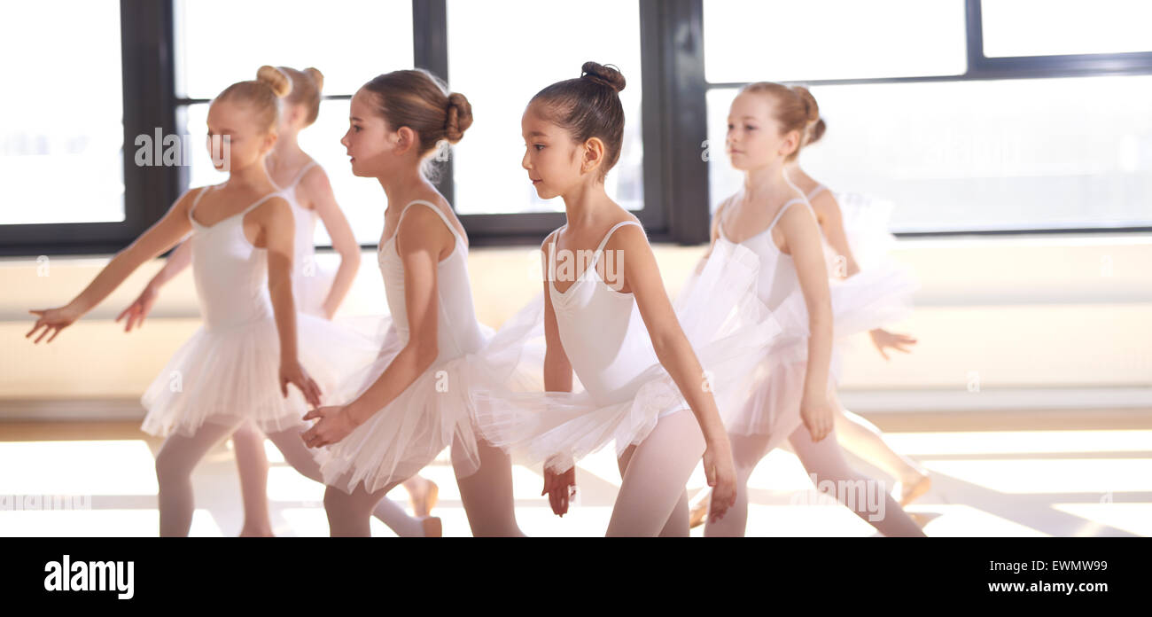 Group of young ballerinas performing a choreographed ballet as they ...