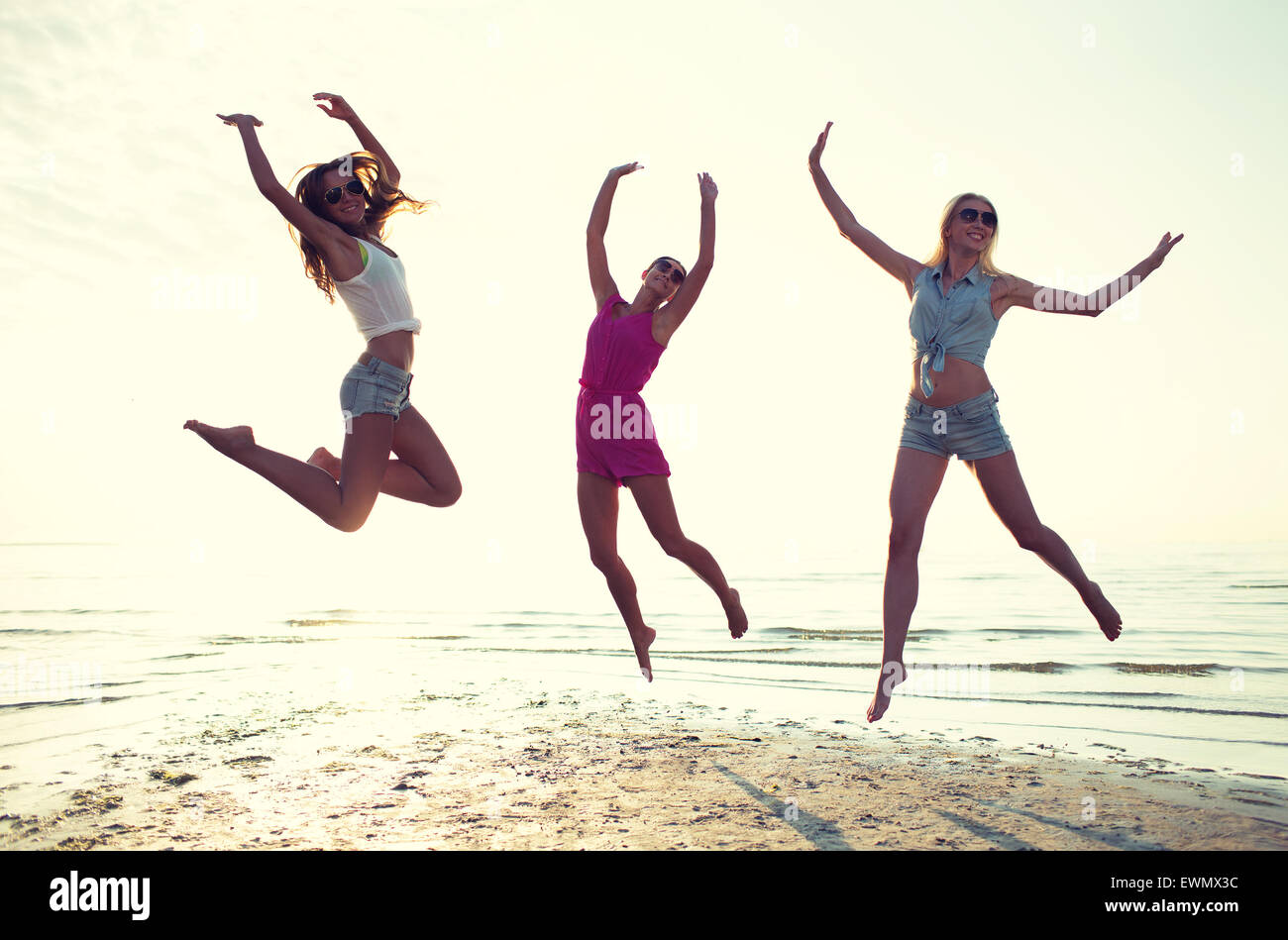 Happy women jumping hi-res stock photography and images - Alamy