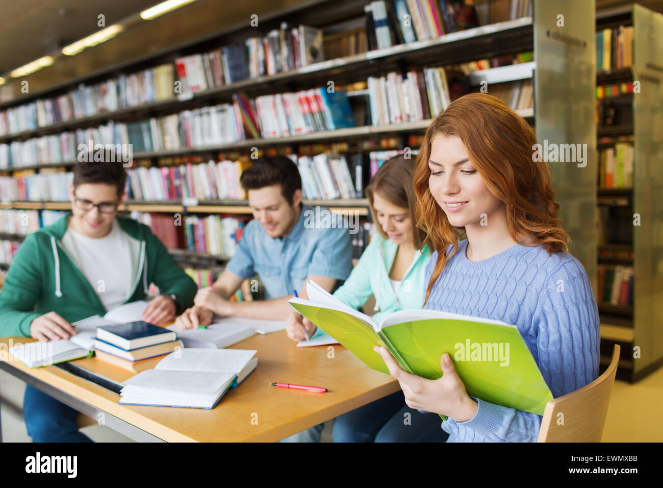 happy students reading books in library Stock Photo - Alamy