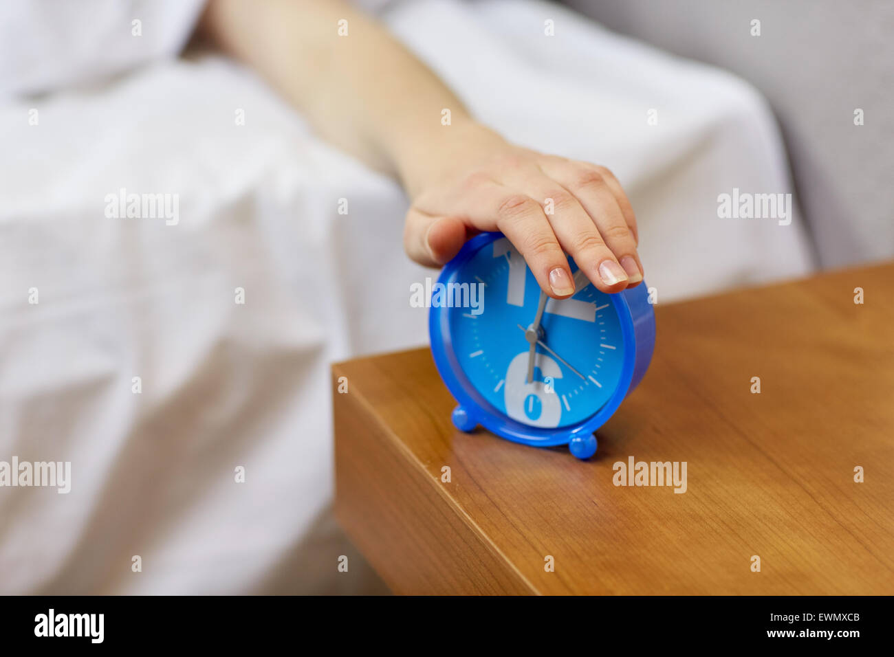 close up of hand on alarm clock in bedroom Stock Photo - Alamy
