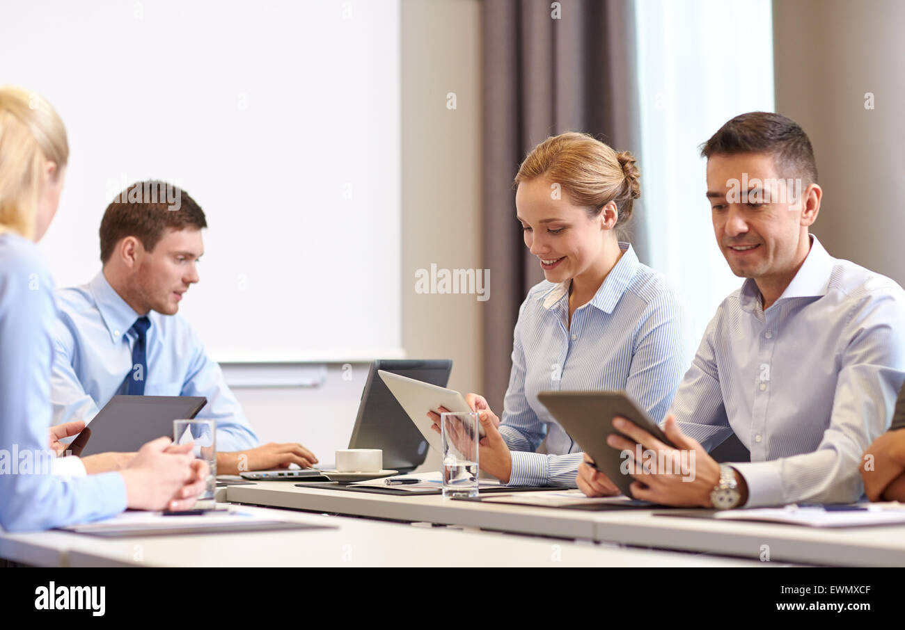 smiling business people with tablet pc in office Stock Photo - Alamy