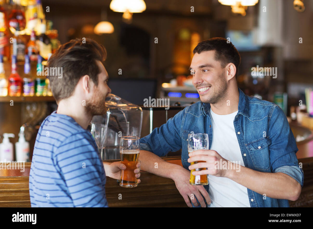 happy male friends drinking beer at bar or pub Stock Photo - Alamy