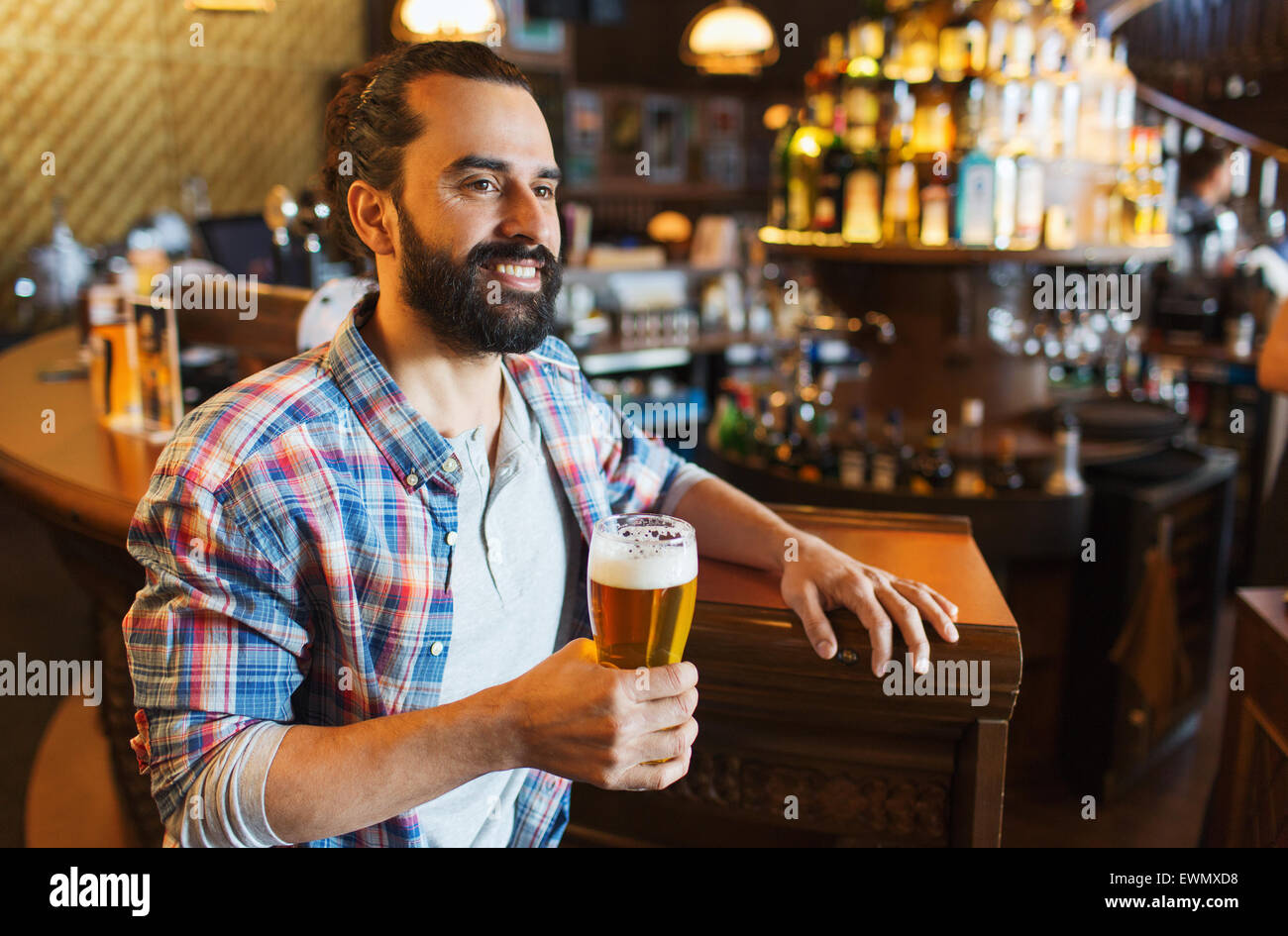 happy man drinking beer at bar or pub Stock Photo - Alamy