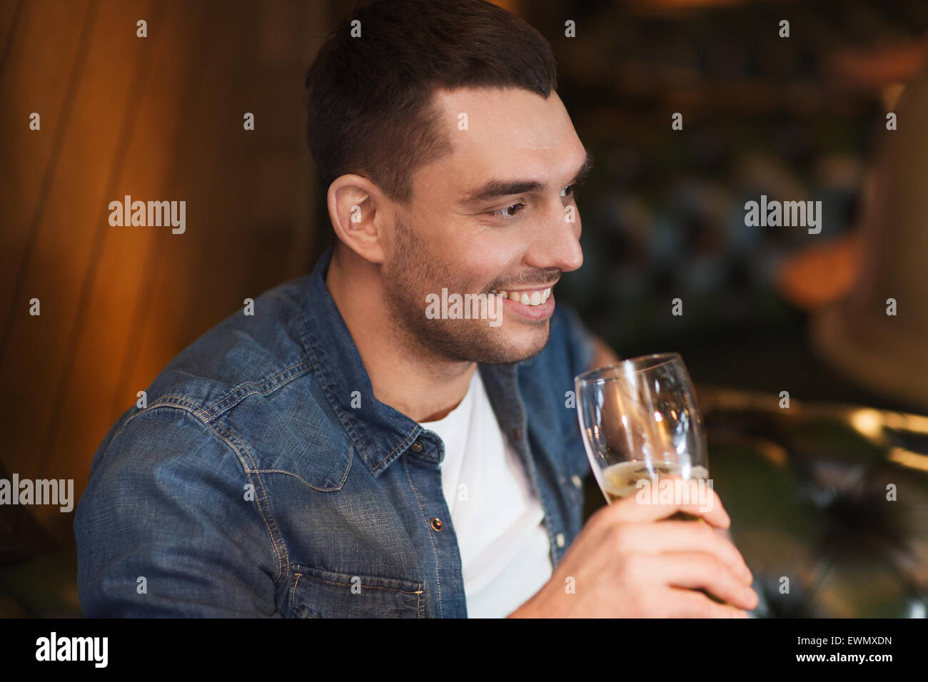 happy man drinking beer at bar or pub Stock Photo - Alamy
