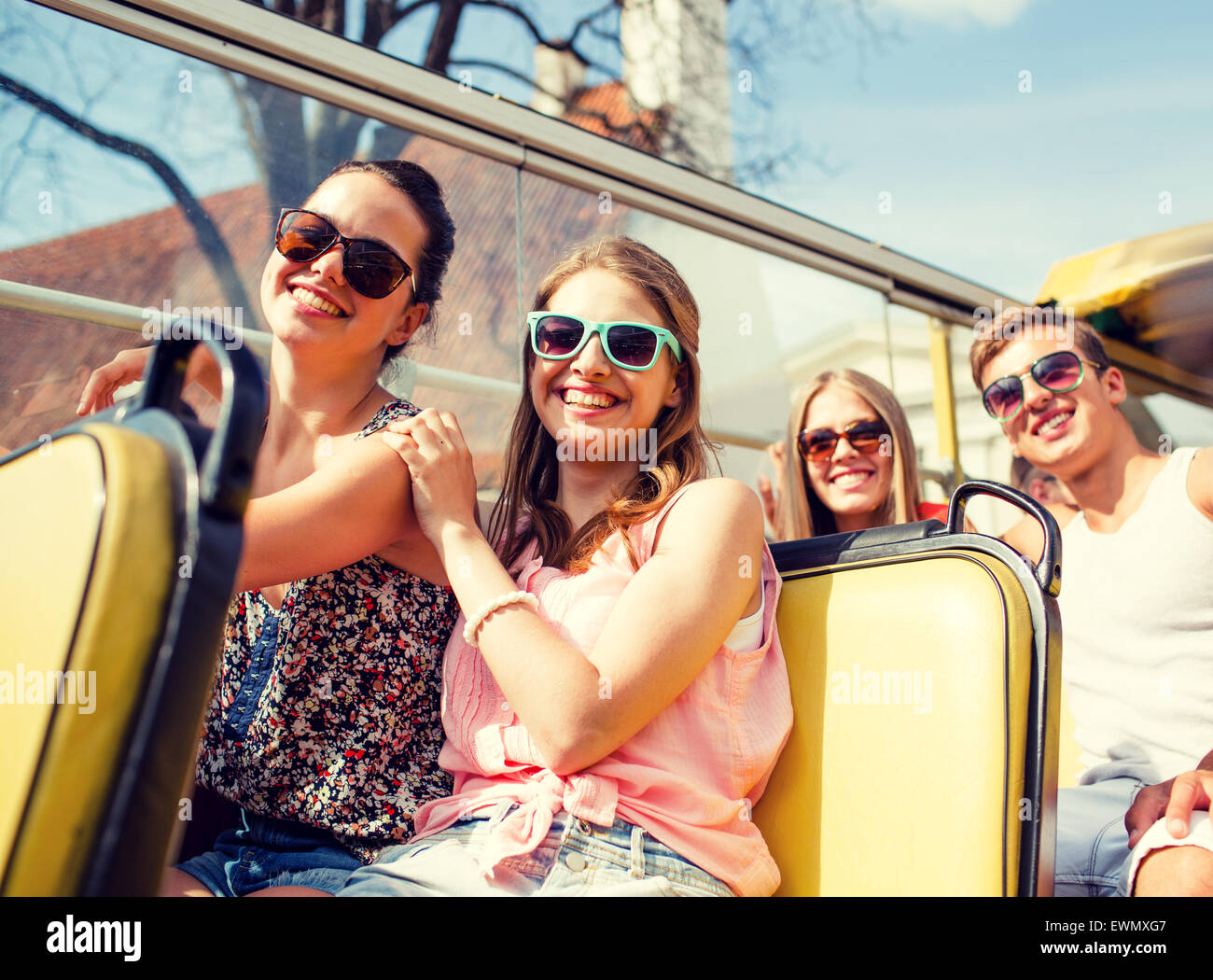 group of smiling friends traveling by tour bus Stock Photo - Alamy