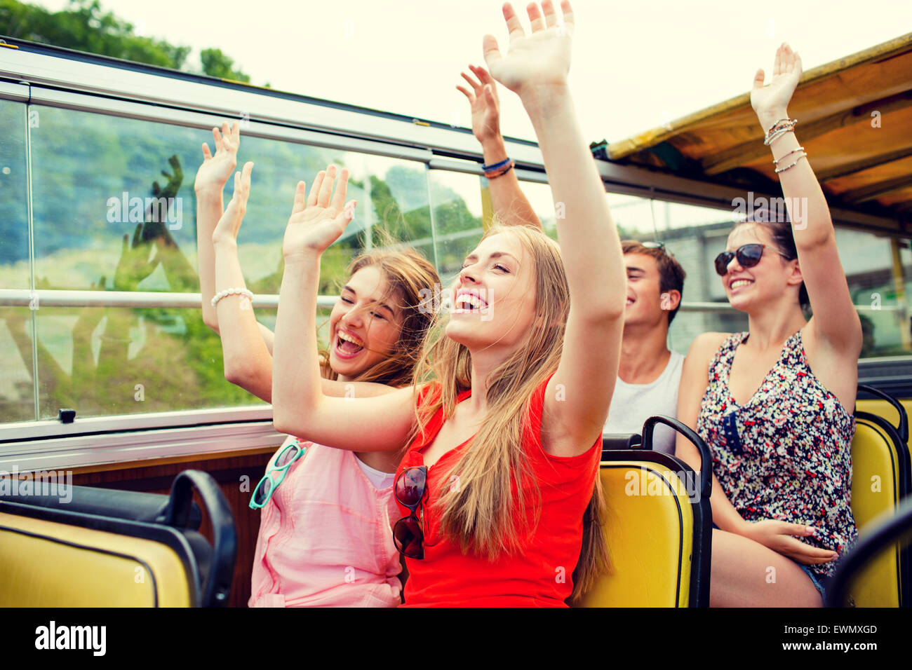 group of smiling friends traveling by tour bus Stock Photo - Alamy