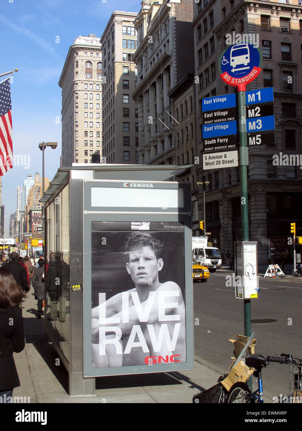 Bust stop in downtown Manhattan with GNC advertising on the side Stock ...