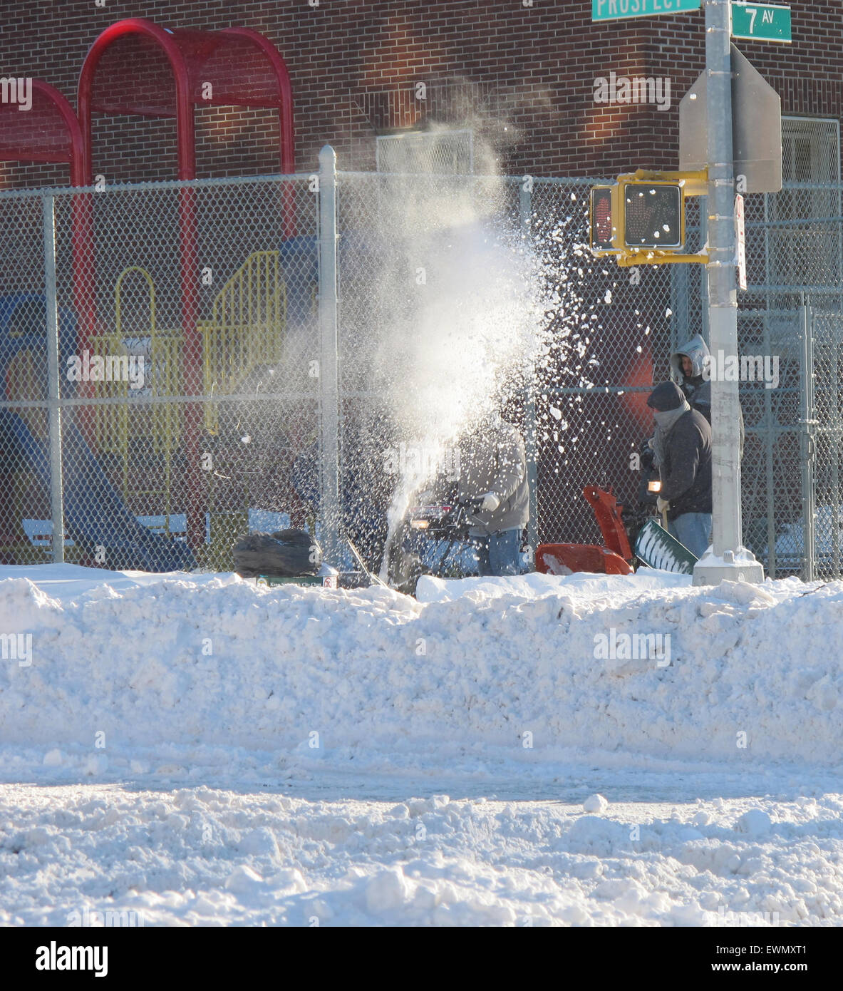 Man pushing snowblower by school playground in winter Stock Photo - Alamy