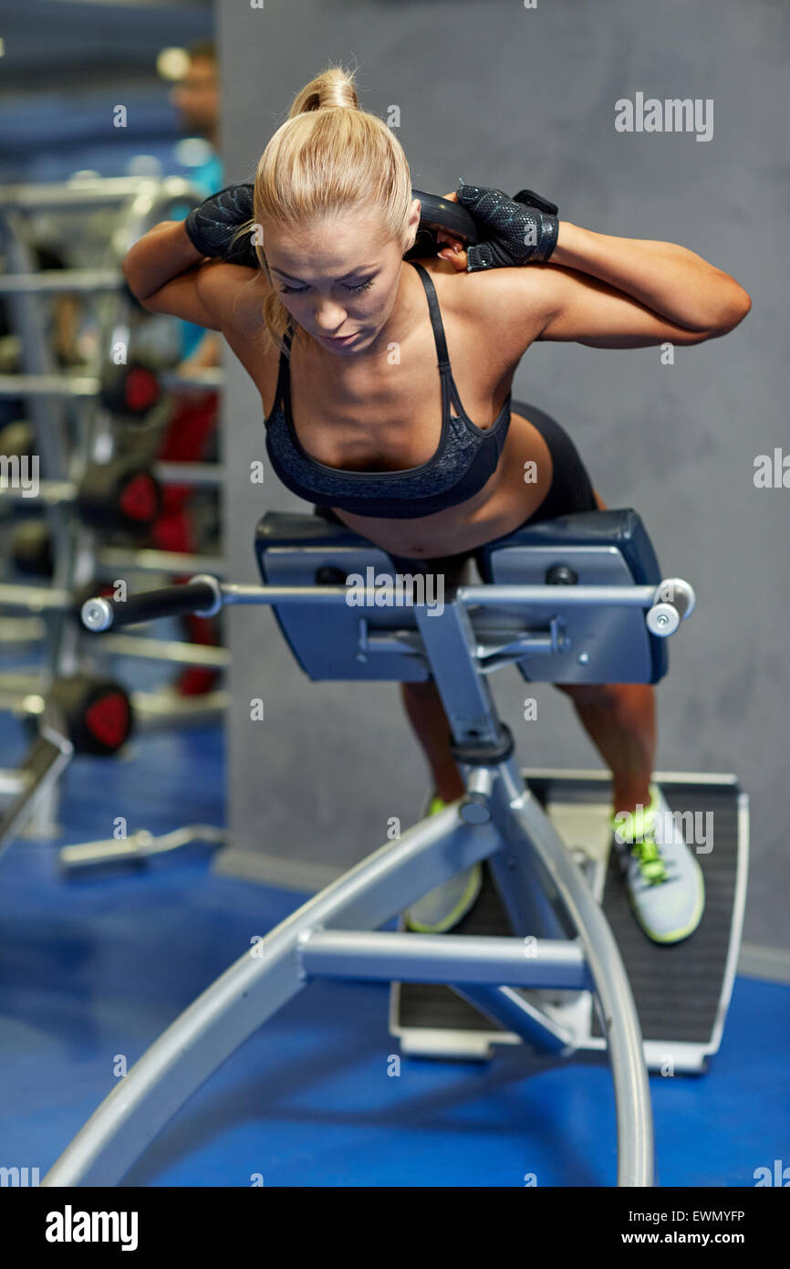 young woman flexing back muscles on bench in gym Stock Photo - Alamy
