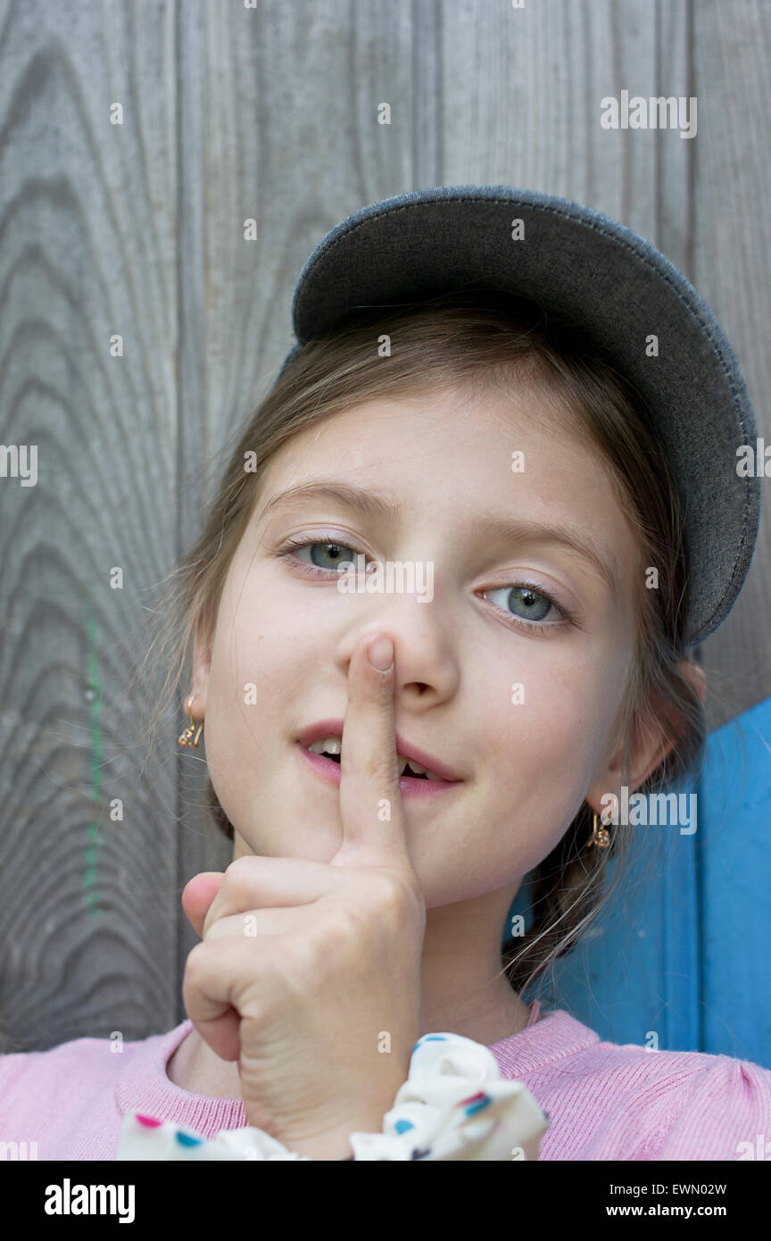 Girl doing a silence gesture Stock Photo - Alamy