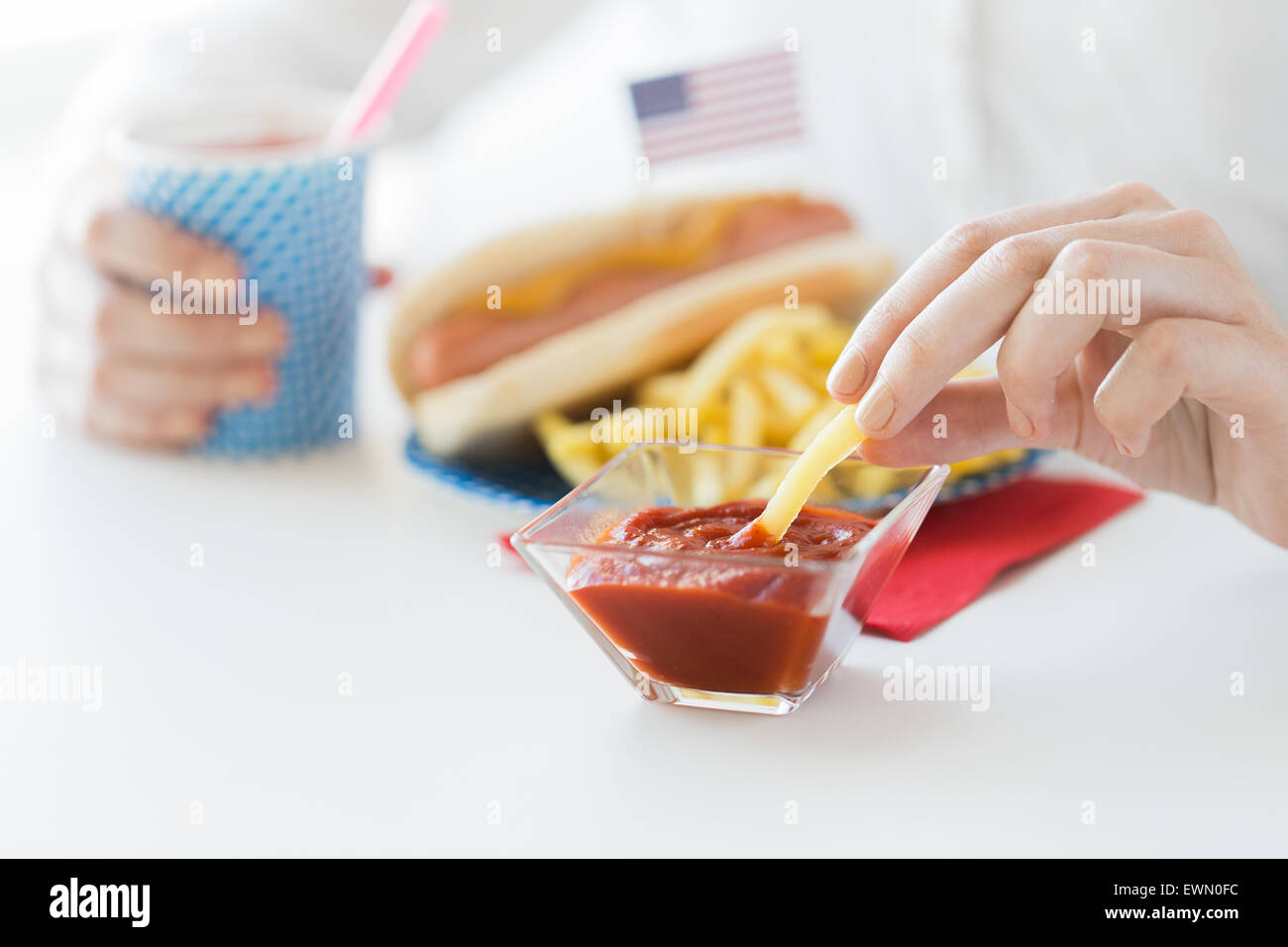 close up of woman hands eating on american food Stock Photo - Alamy