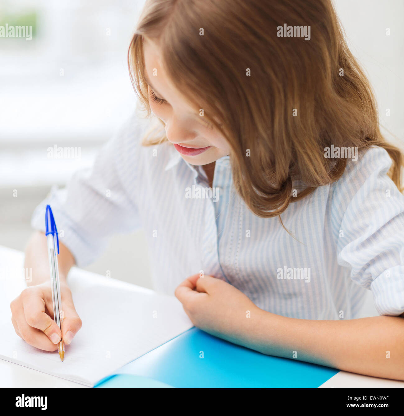 student girl writing in notebook at school Stock Photo - Alamy