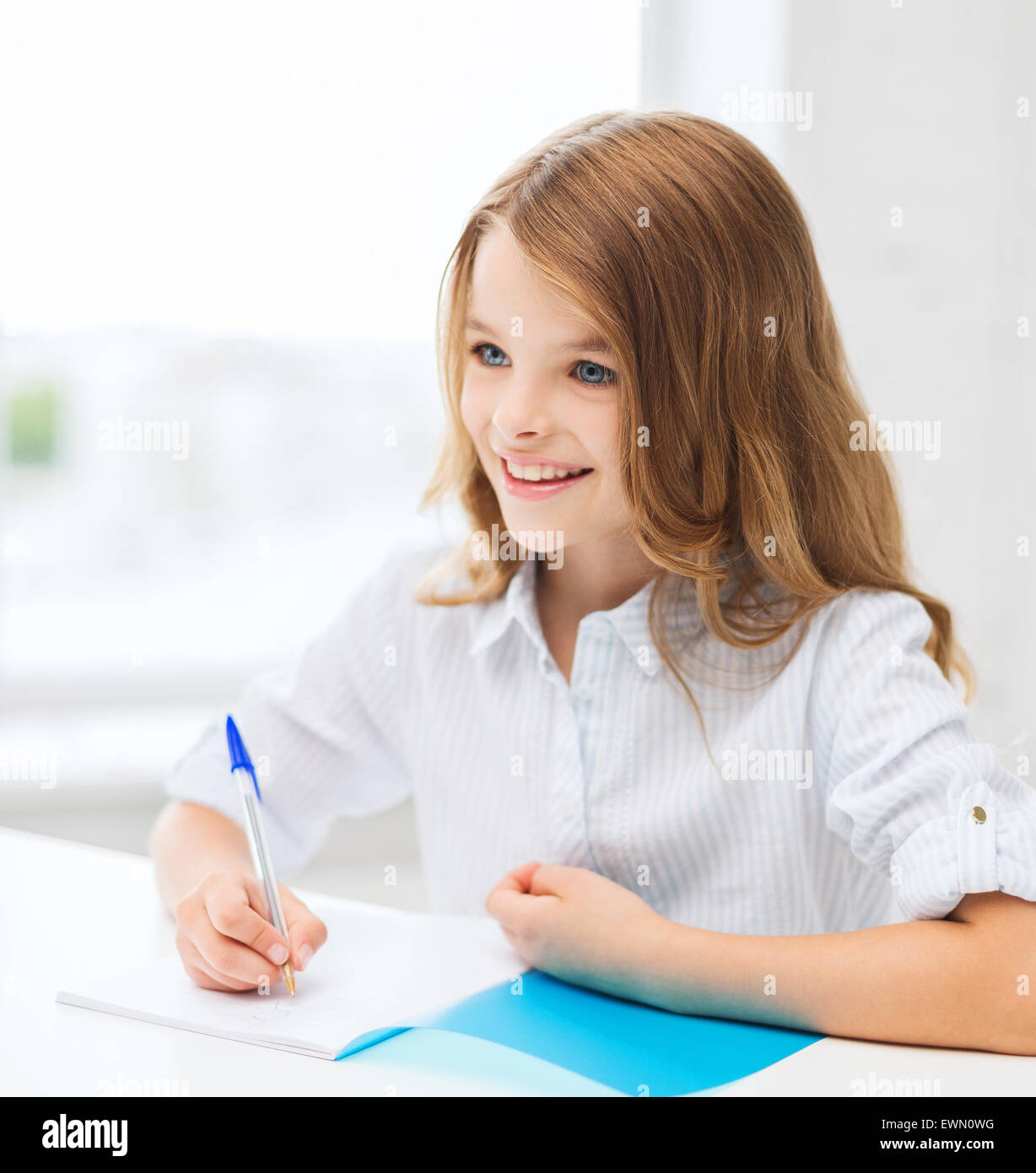 student girl writing in notebook at school Stock Photo - Alamy