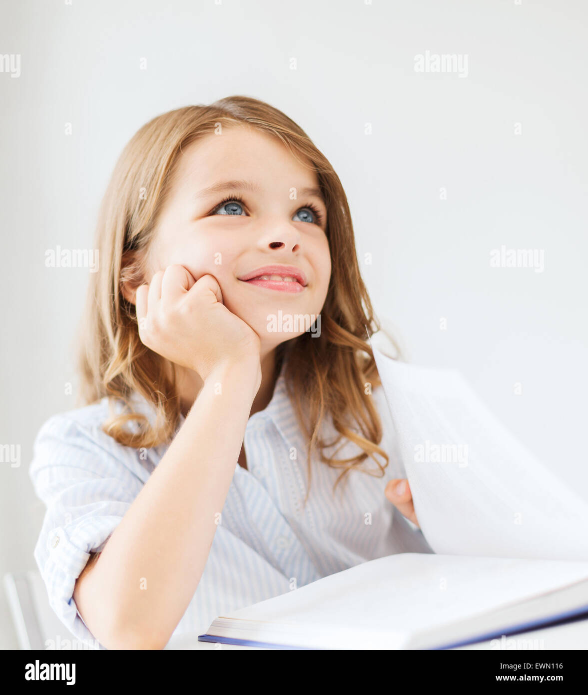 student girl writing in notebook at school Stock Photo - Alamy