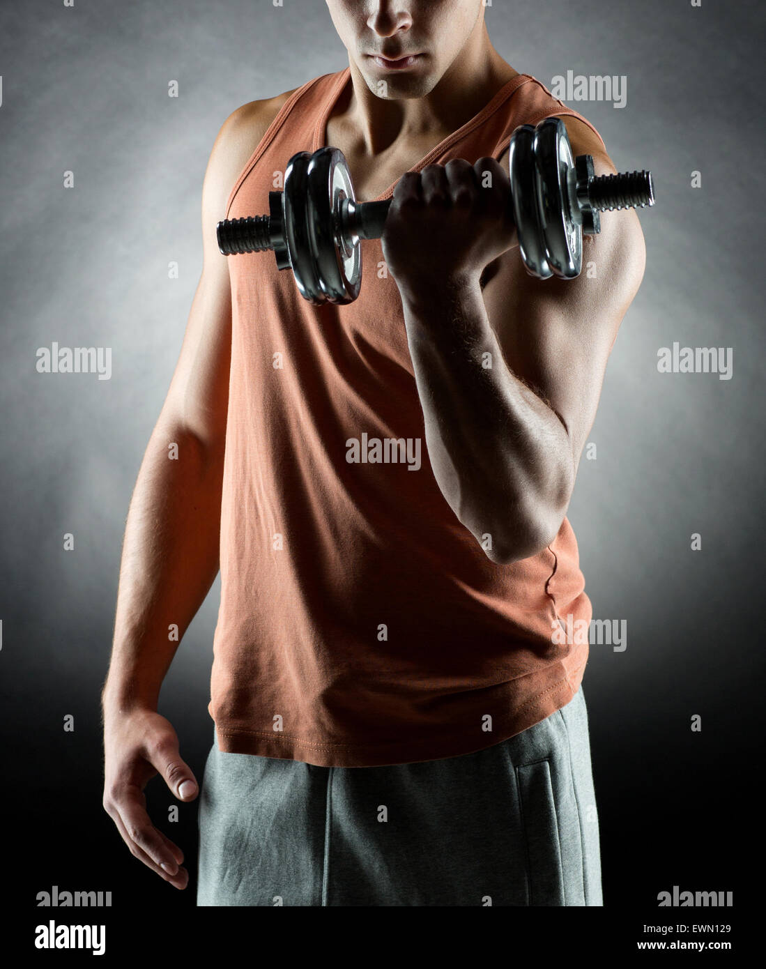young man with dumbbell Stock Photo - Alamy