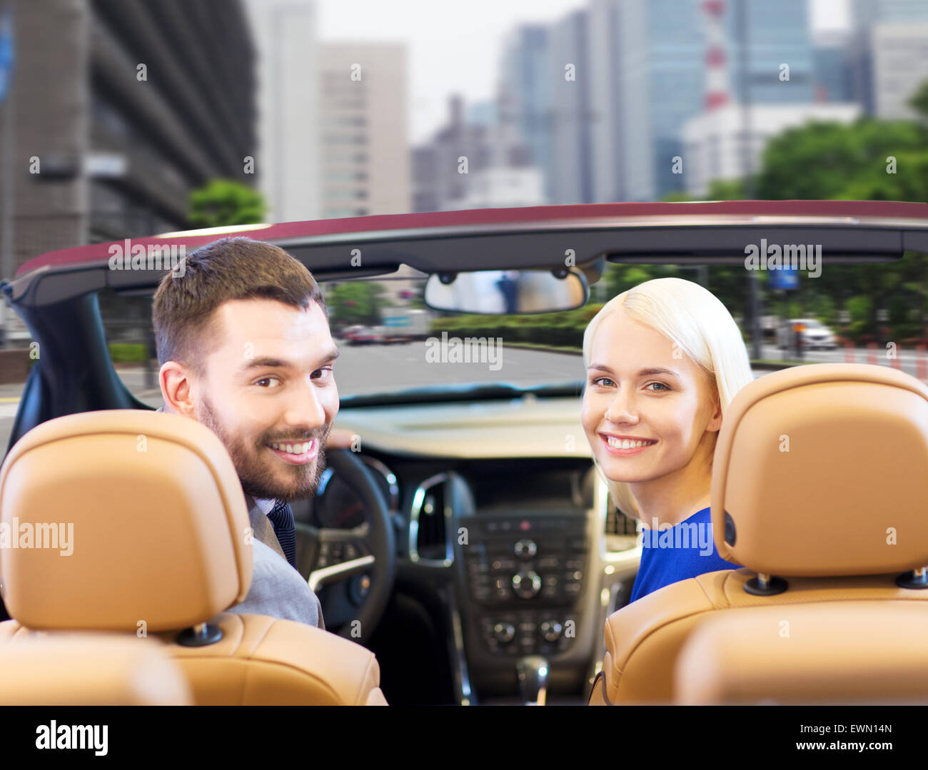 happy couple driving in cabriolet car over city Stock Photo - Alamy