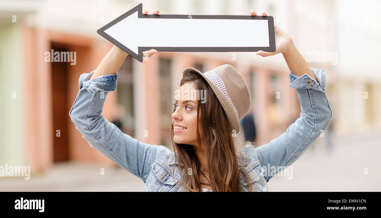 girl showing direction with arrow in the city Stock Photo - Alamy