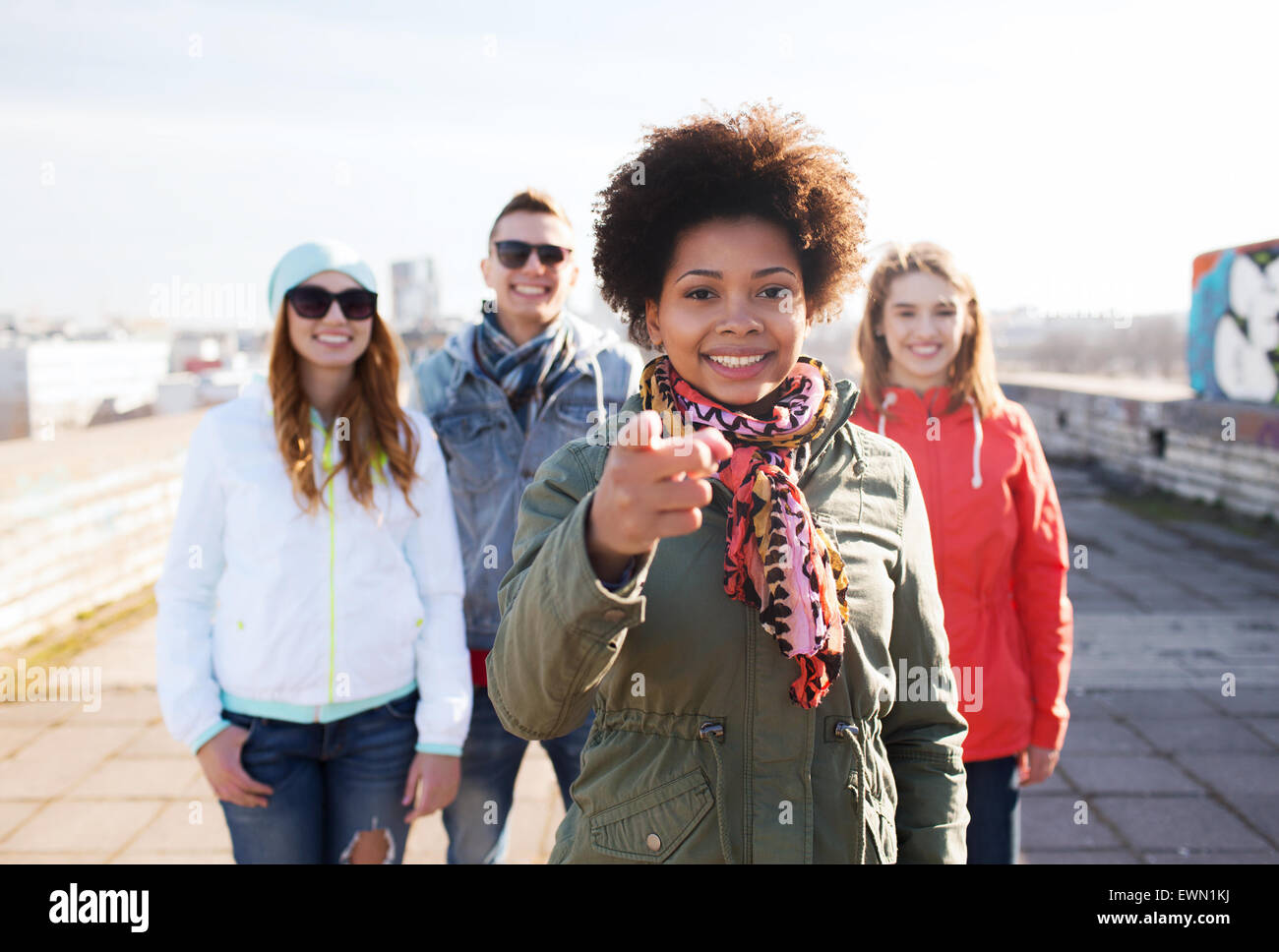 happy friends pointing finger to you on street Stock Photo - Alamy