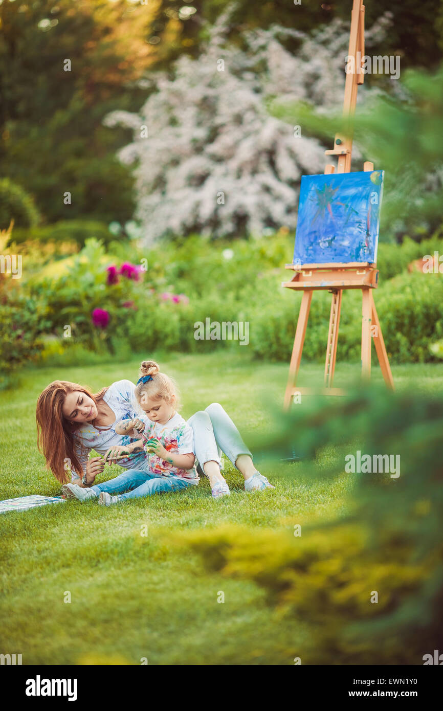 Mother and little daughter paint together Stock Photo - Alamy