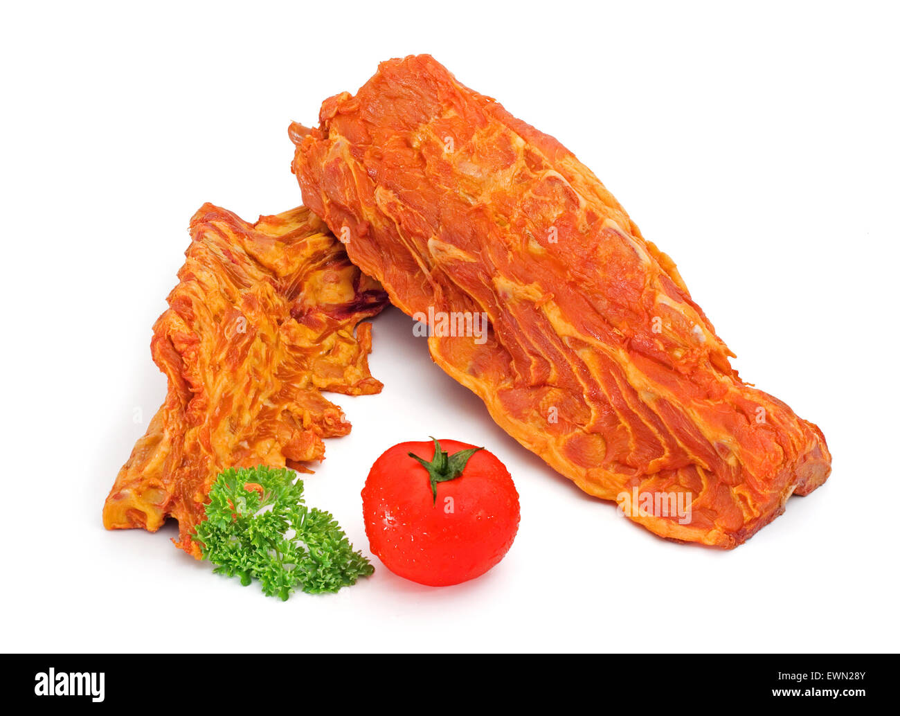 Spicy pork loin rack joint with tomato and parsley decoration Stock ...