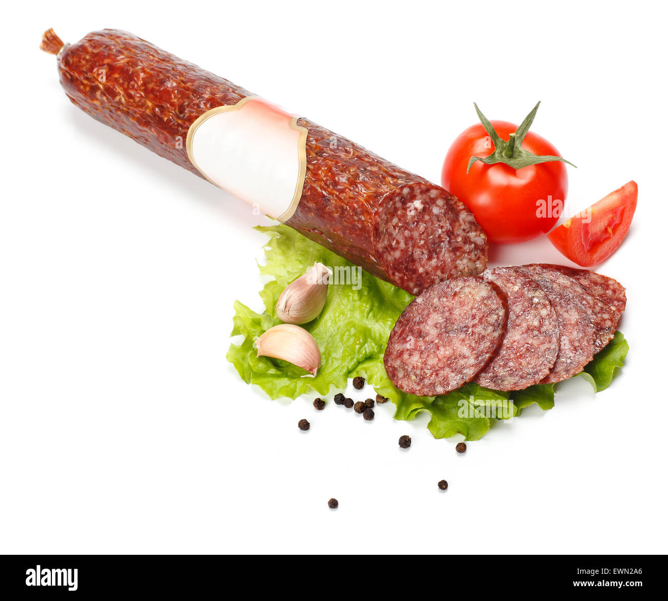 Salami stick with blank label and slices around, vegetables around ...