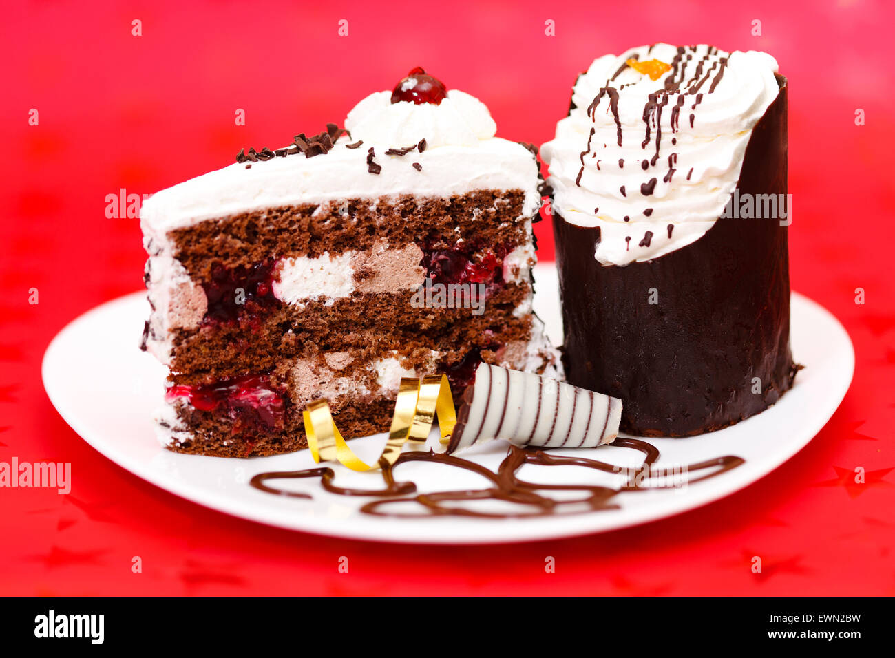 Two slice chocolate fancy cake on red background Stock Photo - Alamy