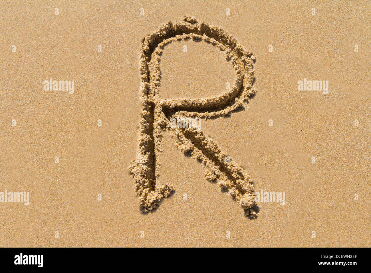 Alphabet writing on sand letter hi-res stock photography and images - Alamy